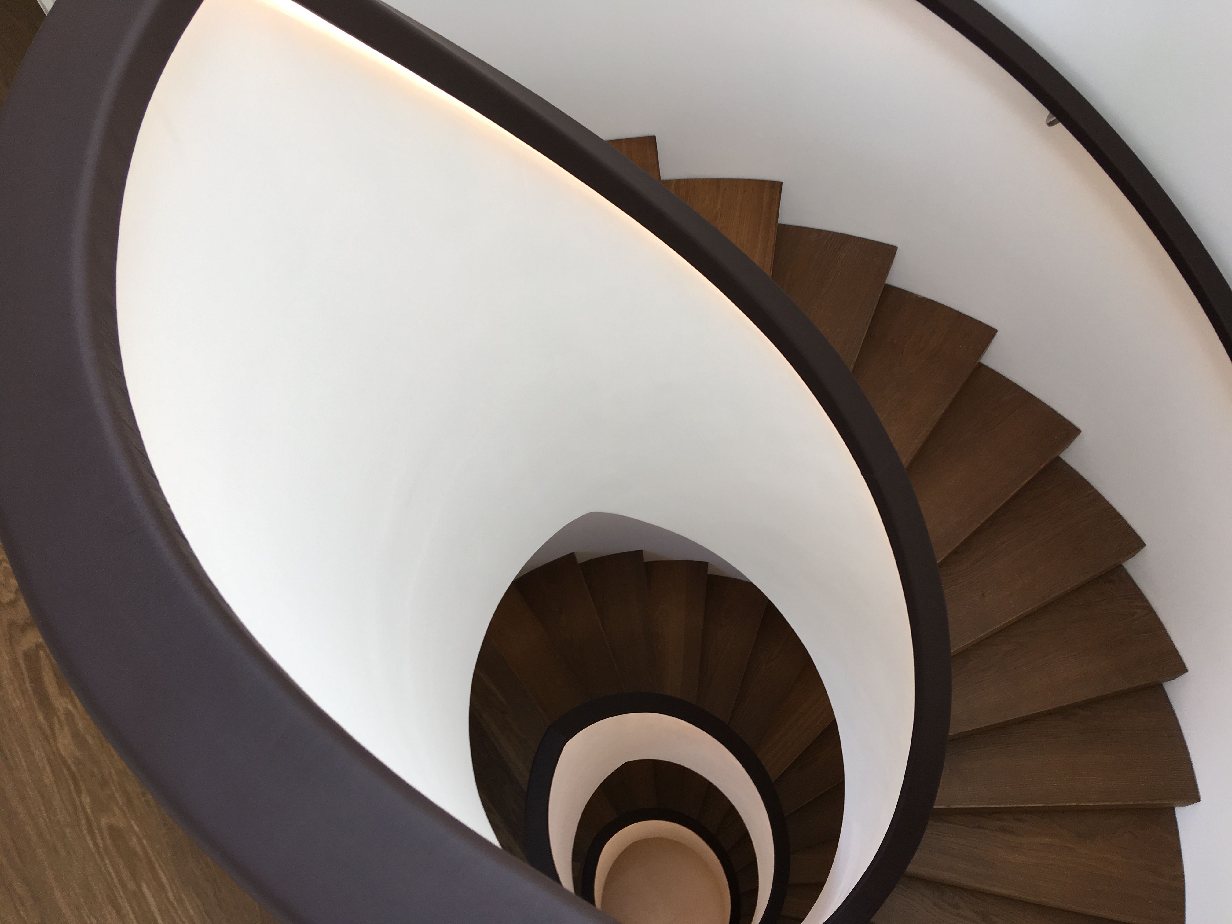 Spiral leather handrail covered on-site by Hide and Stitch